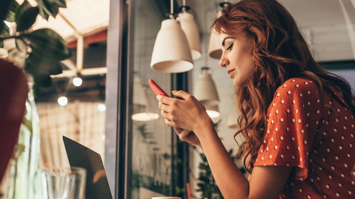 Side,View,Of,Young,Woman,Using,Smartphone,At,Table,With - TRiP EDiTOR